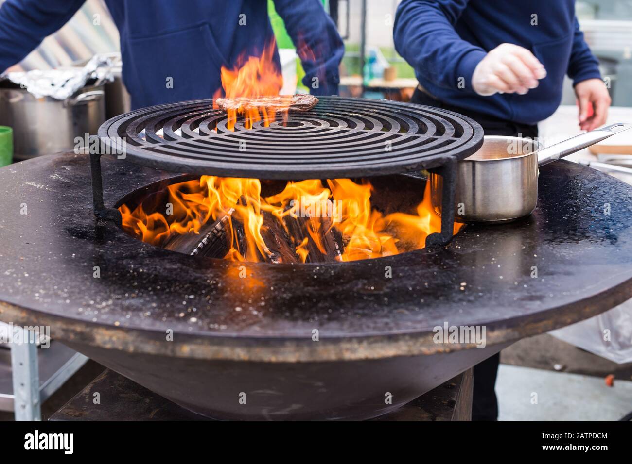 Outdoor wood-burning grill for frying steaks and pork ribs over an open ...
