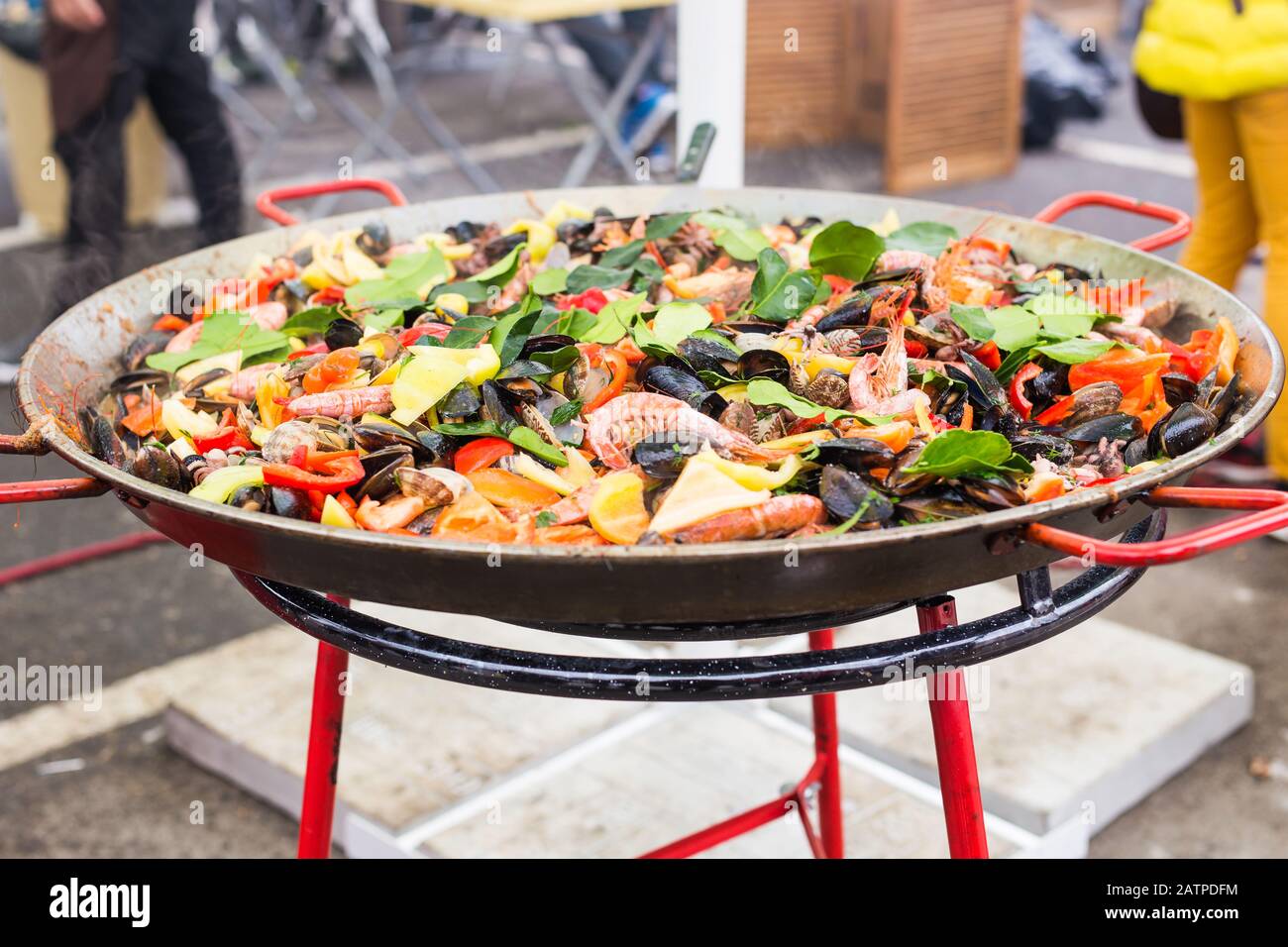 Street food and meal - Spanish paella close-up with shrimp and clams ...