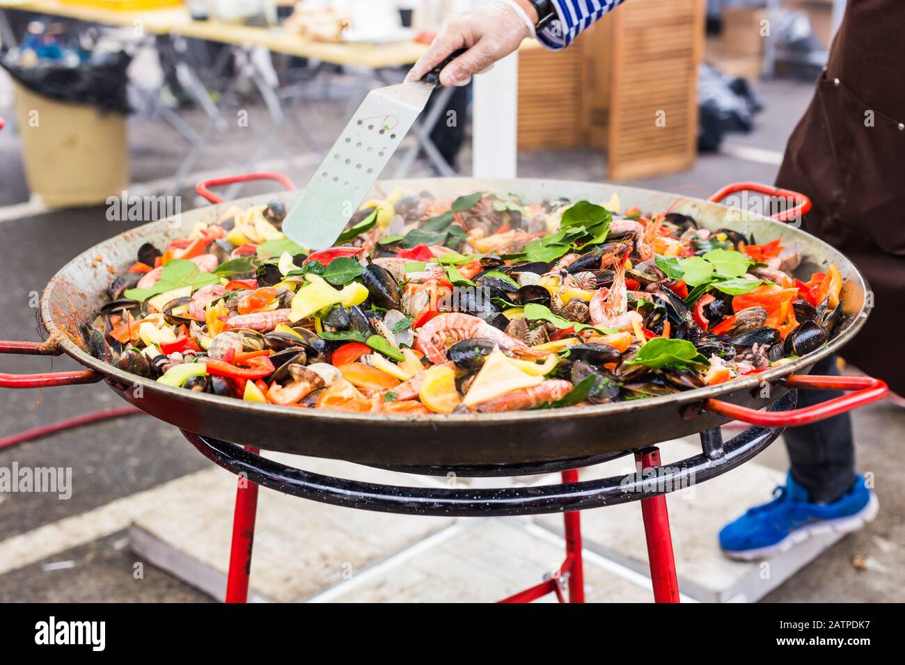 Street food concept - Gourmet seafood paella with pink marine prawns ...