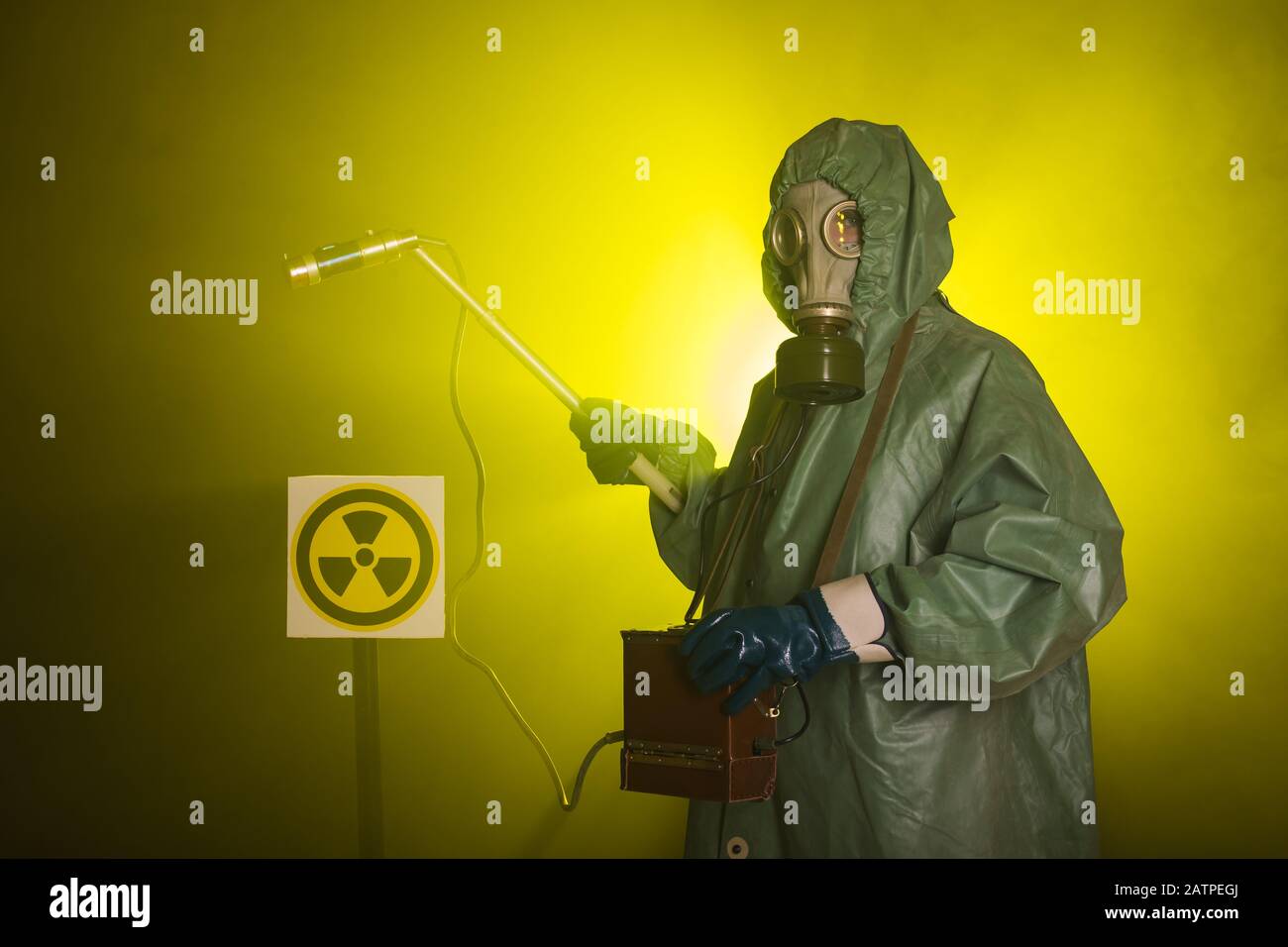 Man in the gas mask and chemical suit. The worker doing measure ...
