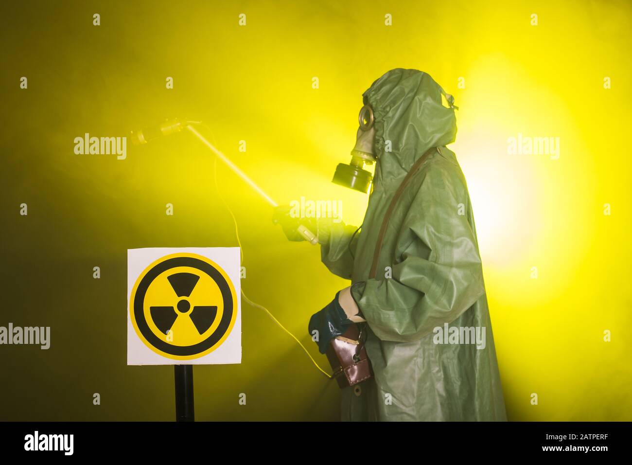 Man in the gas mask and chemical suit. The worker doing measure ...