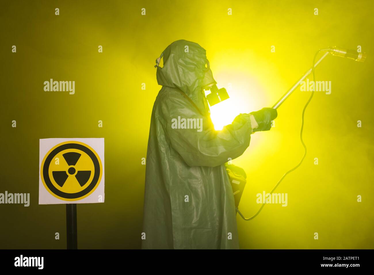 Man in the gas mask and chemical suit. The worker doing measure ...