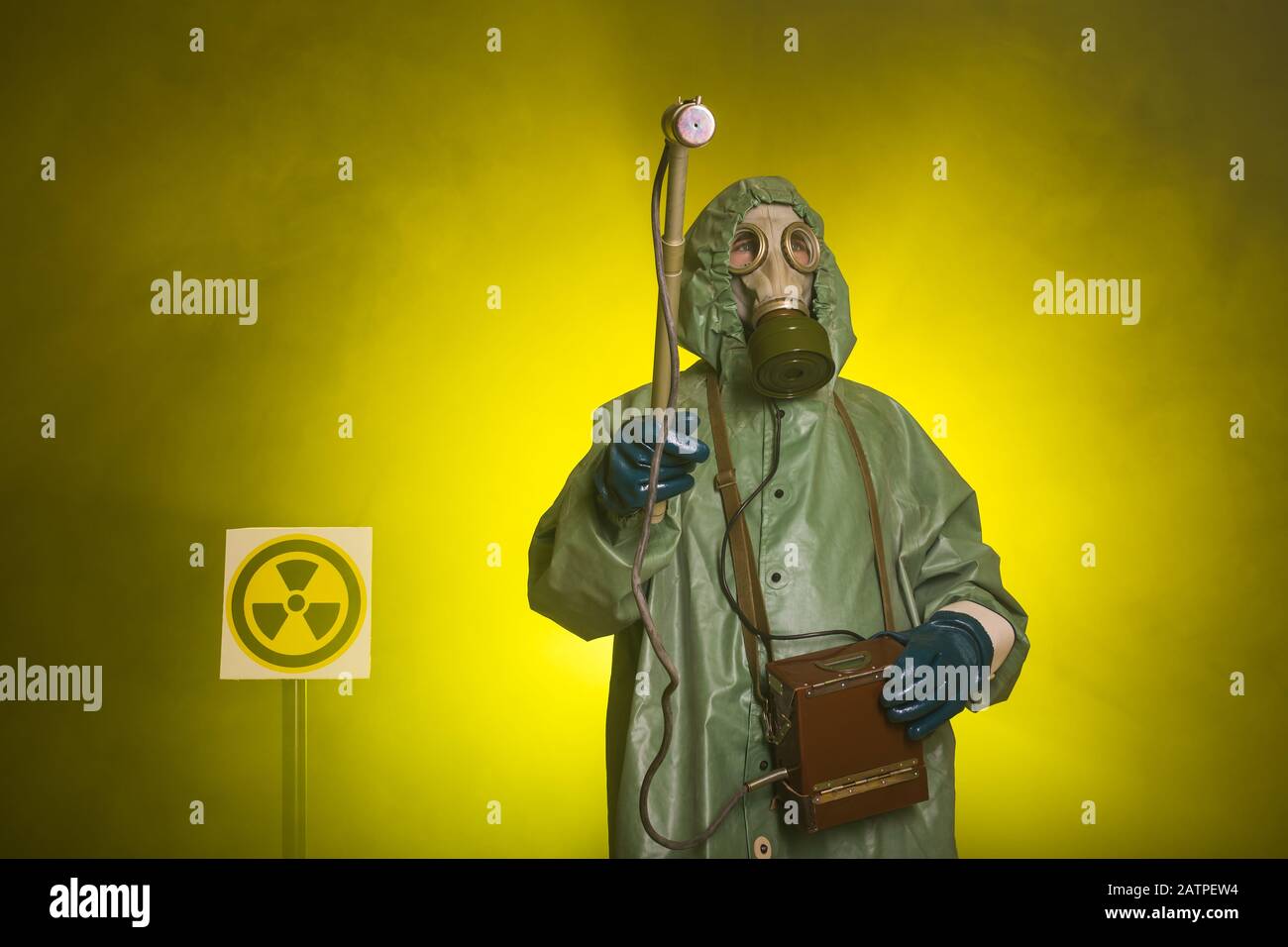 Man in the gas mask and chemical suit. The worker doing measure ...