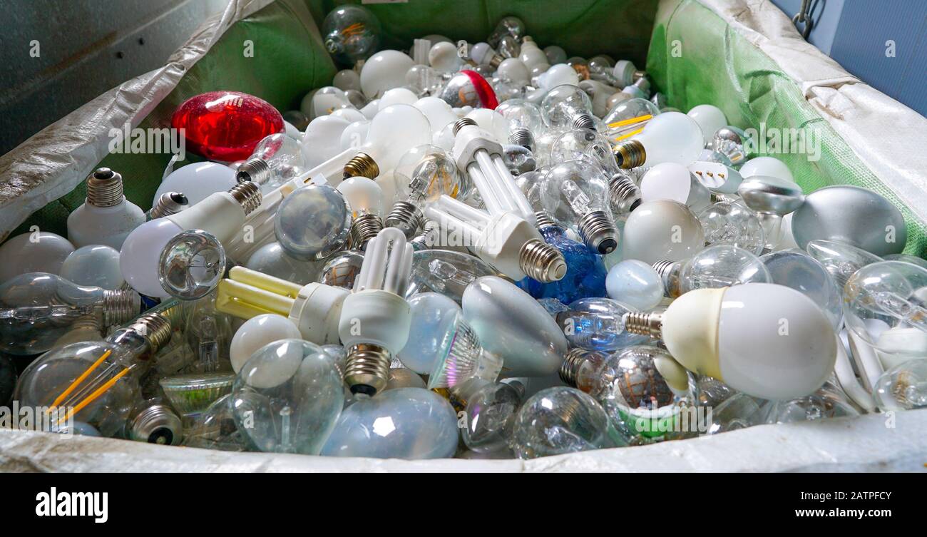 A selective focus view of a large recycling bin filled with many ...