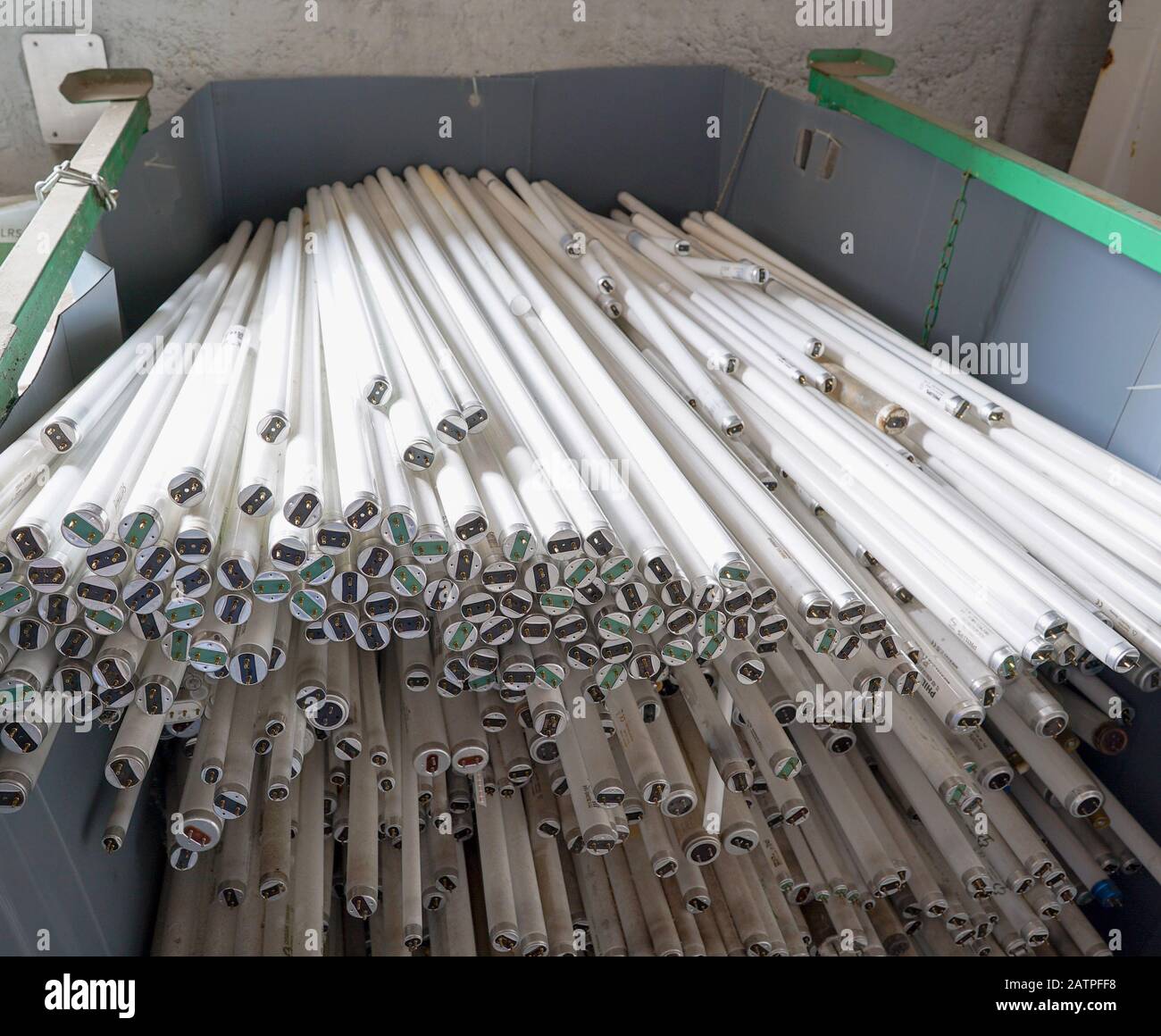 A selective focus view of large recycling bin filled with stacks of ...