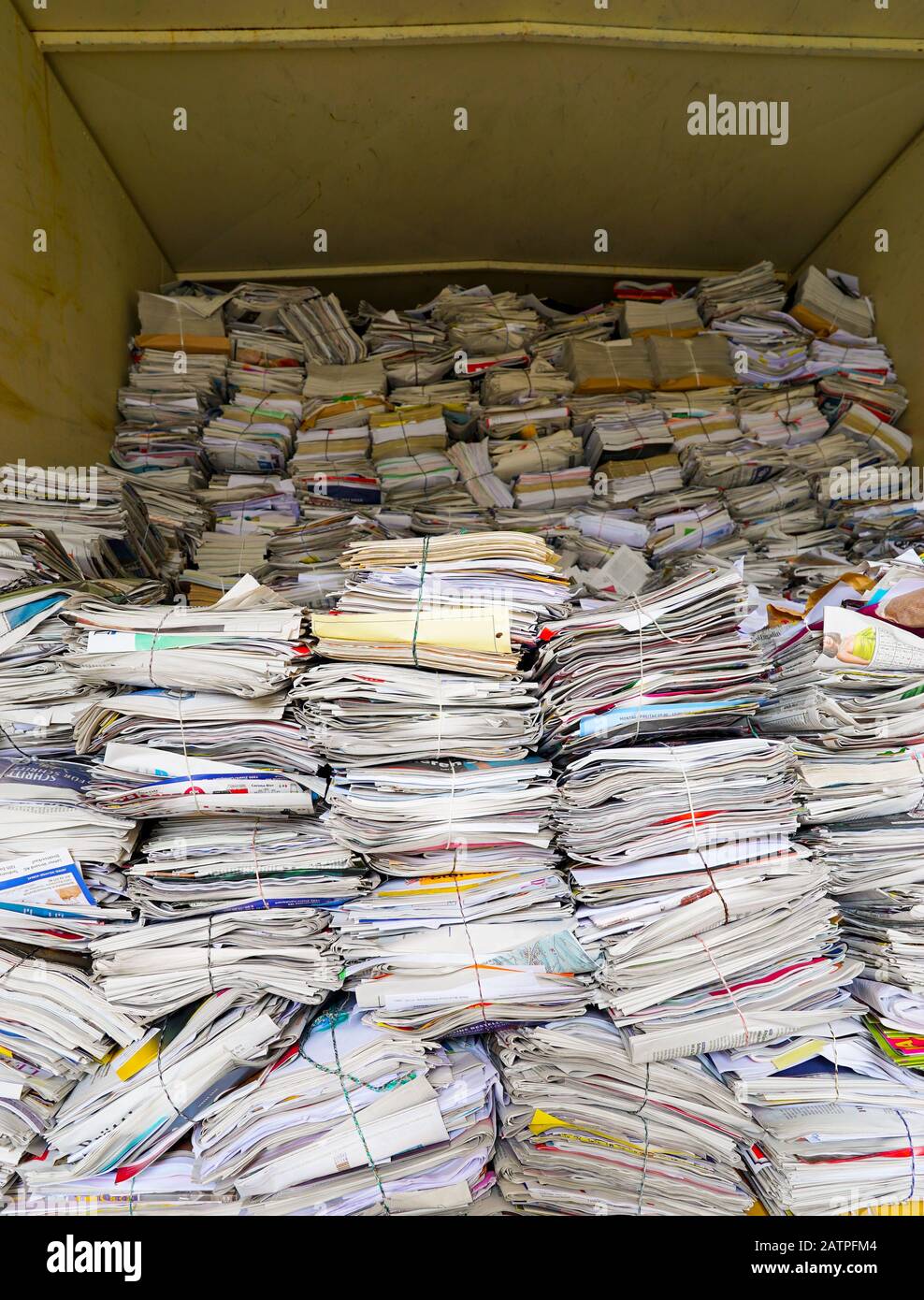 A vertical view of stacks of paper and magazines and newspapers ready ...
