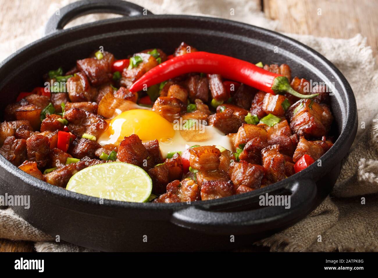 Spicy and sizzling pork sisig is a favorite for Filipinos close-up in a ...