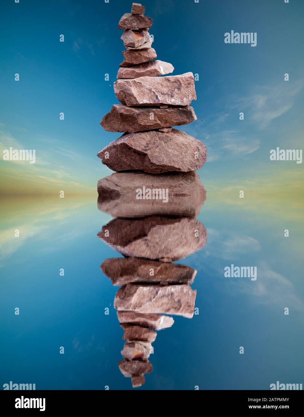 Several stones in balance and its reflection in the water, manipulation ...