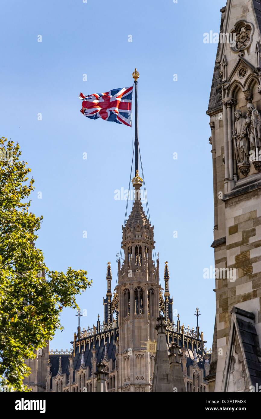 Top of tower of houses of parliament with british flag hi-res stock ...