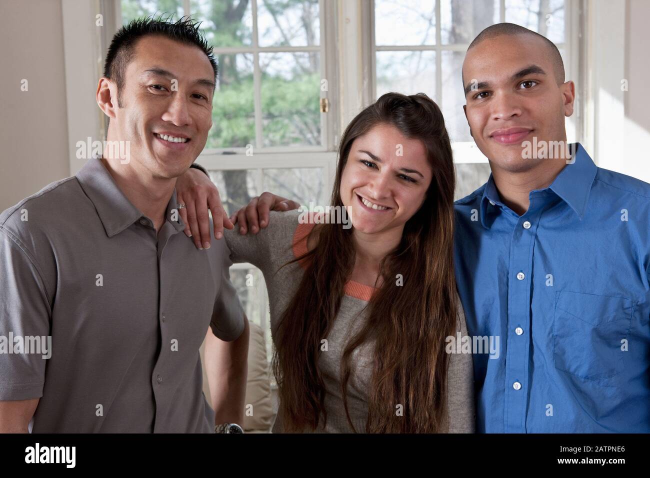 Three friends standing in embrace hi-res stock photography and images ...