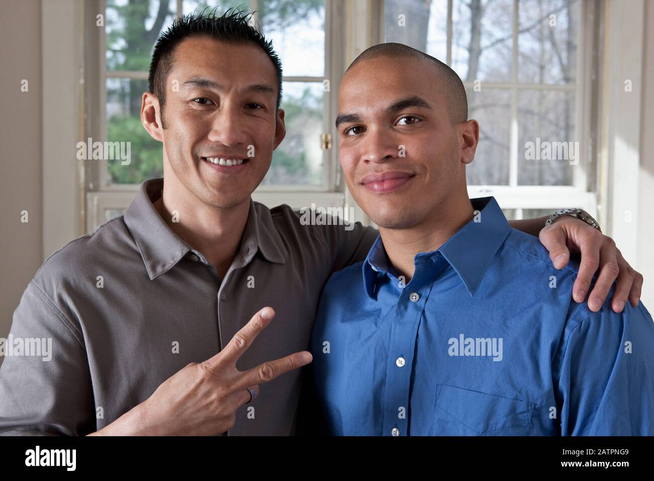 Two men standing side by side hi-res stock photography and images - Alamy