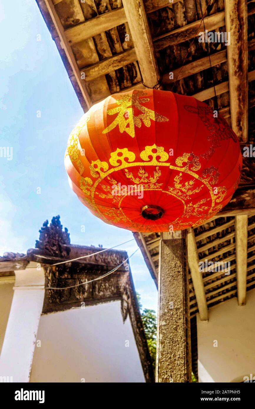 A beautiful bright red lantern hanging on an ancient Farm House Villa ...