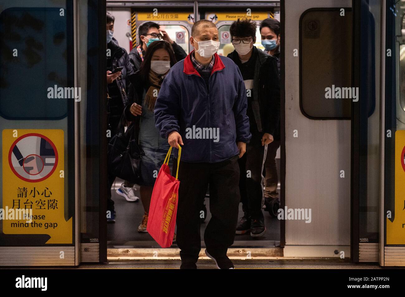 Commuters wearing face masks exit MTR subway train in Admiralty station ...