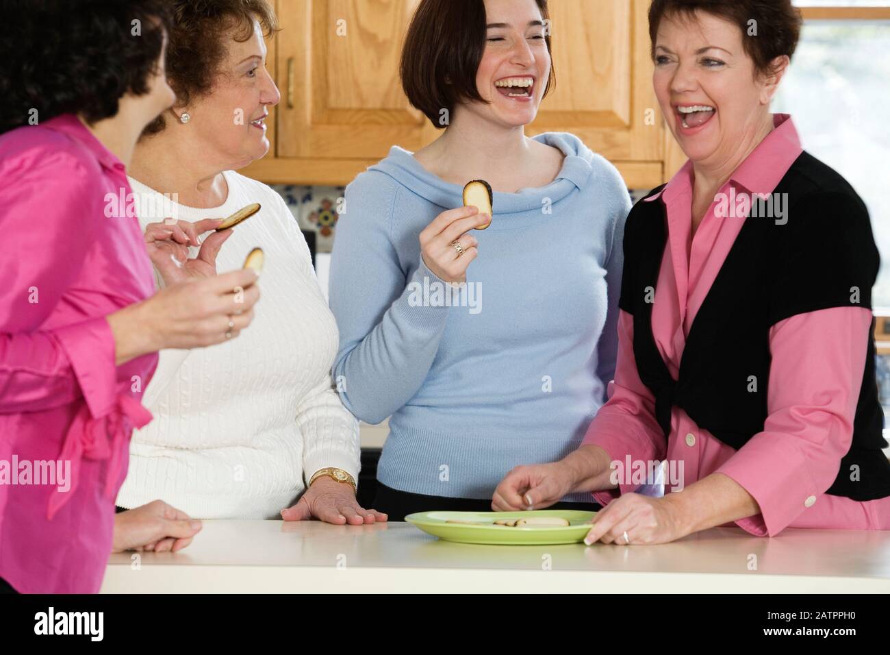 Cheerful women eating chips Stock Photo - Alamy