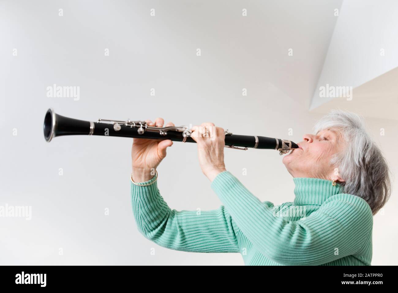 Side view of a mature woman playing a clarinet Stock Photo - Alamy