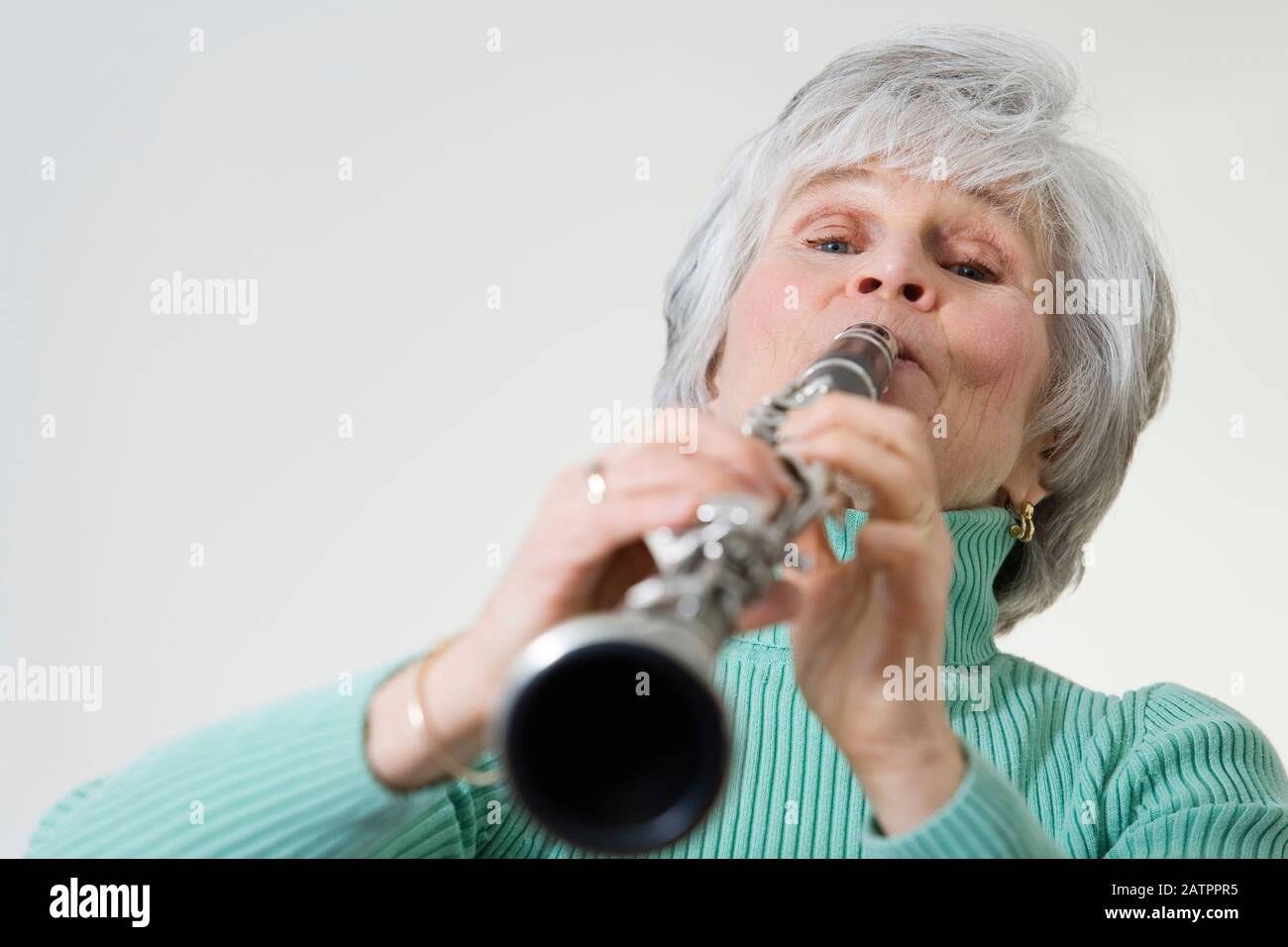 Portrait of a mature woman playing a clarinet Stock Photo - Alamy