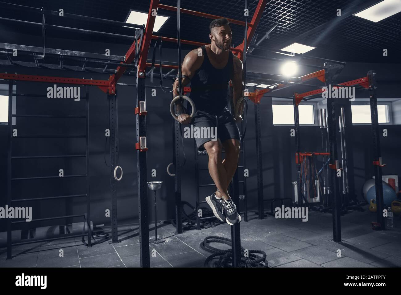 Flying hard. Young muscular caucasian athlete practicing pull-ups in ...