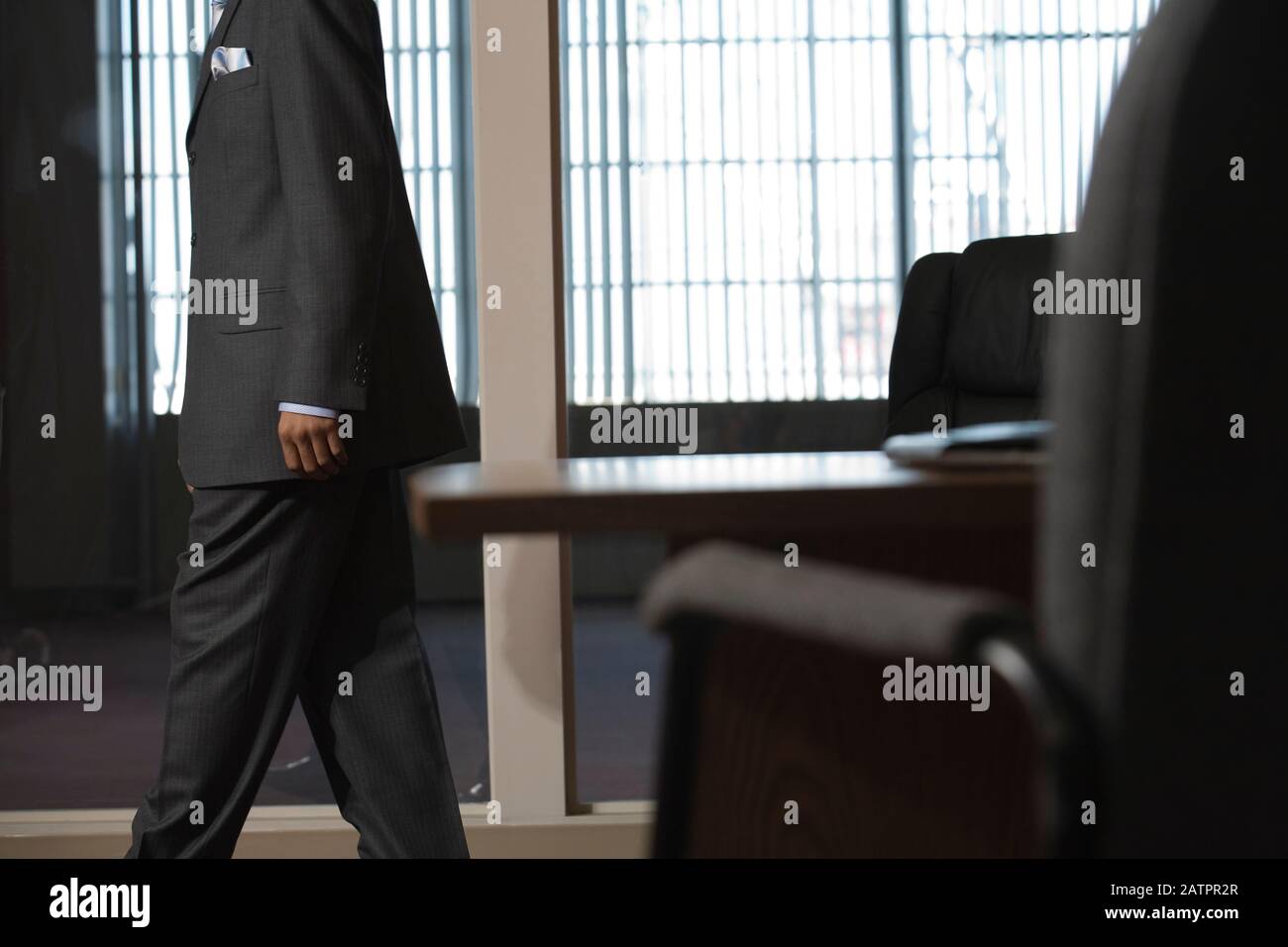 A business man walking in an office Stock Photo - Alamy