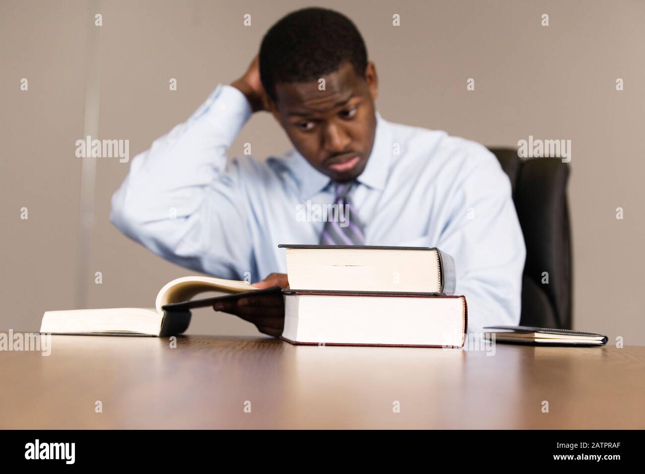 View of business man with books in an office Stock Photo - Alamy
