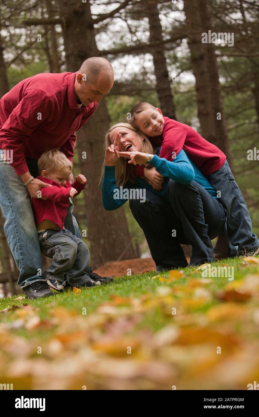 Family playing in a park with a deaf son Stock Photo - Alamy