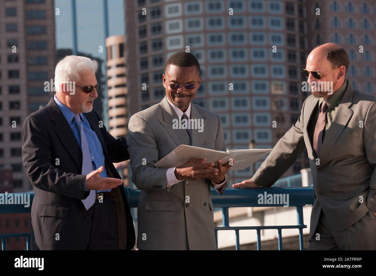 Businessmen going over a document together Stock Photo - Alamy