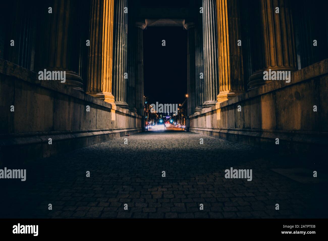 dramatic dark path through ancient columns Stock Photo - Alamy
