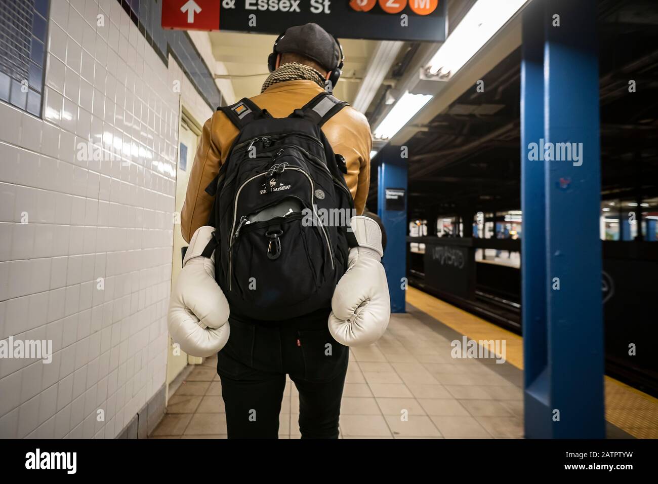A commuter in the Delancey Street station on the subway in New York ...