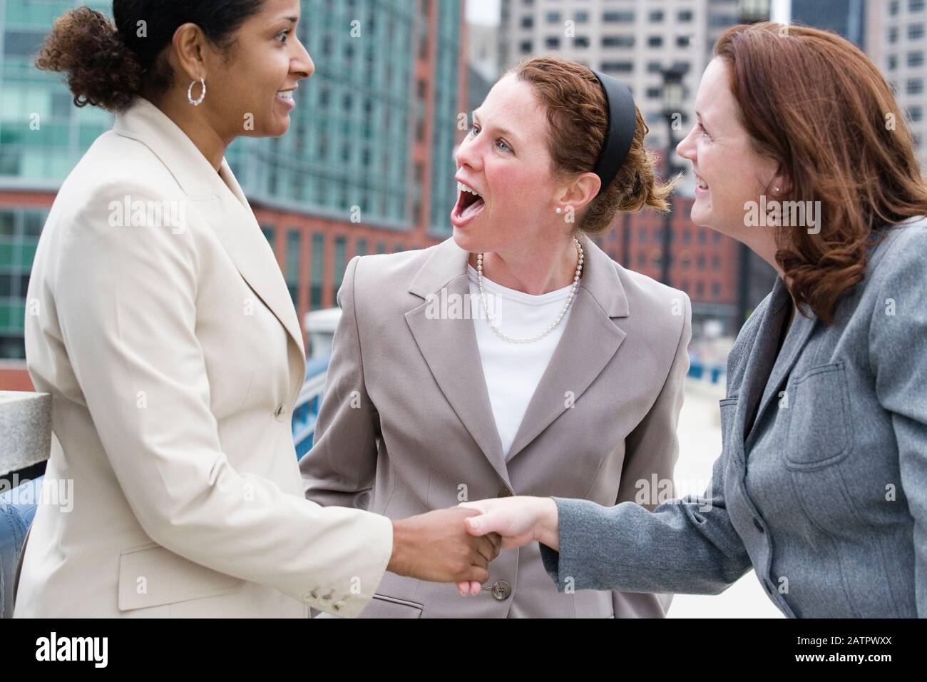Close up of three women shaking hands Stock Photo - Alamy