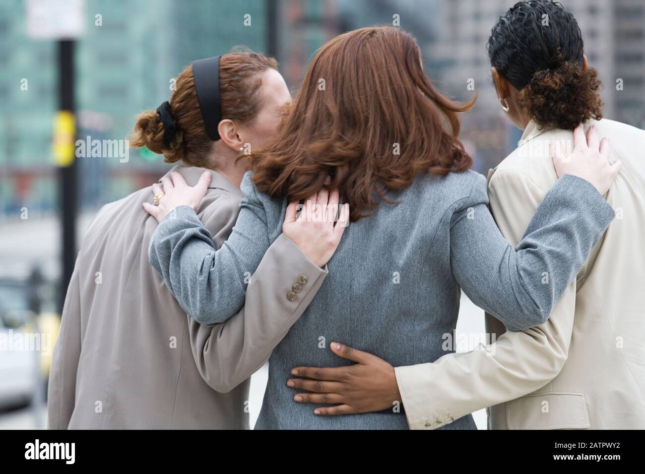 Rear view of three women standing together Stock Photo - Alamy
