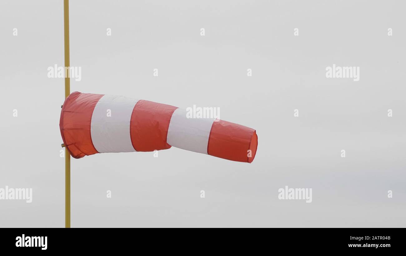 Frayed windsock in moderate wind hi-res stock photography and images ...
