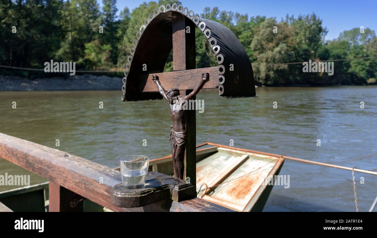 Small altar with Jesus Christ on an old small wooden boat, floating on ...