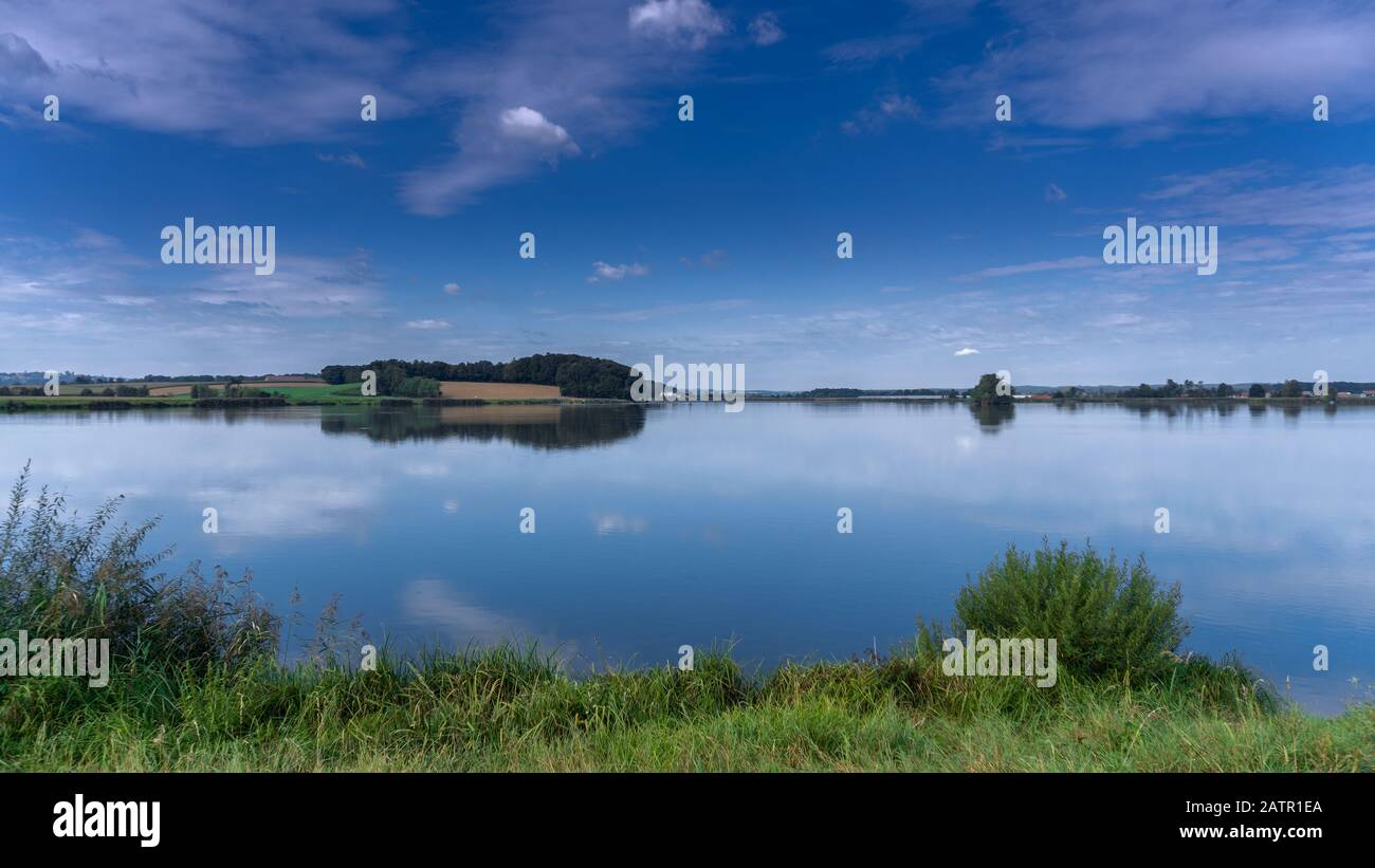 Beautiful quiet lake view with blue sky white clouds, reflection on ...