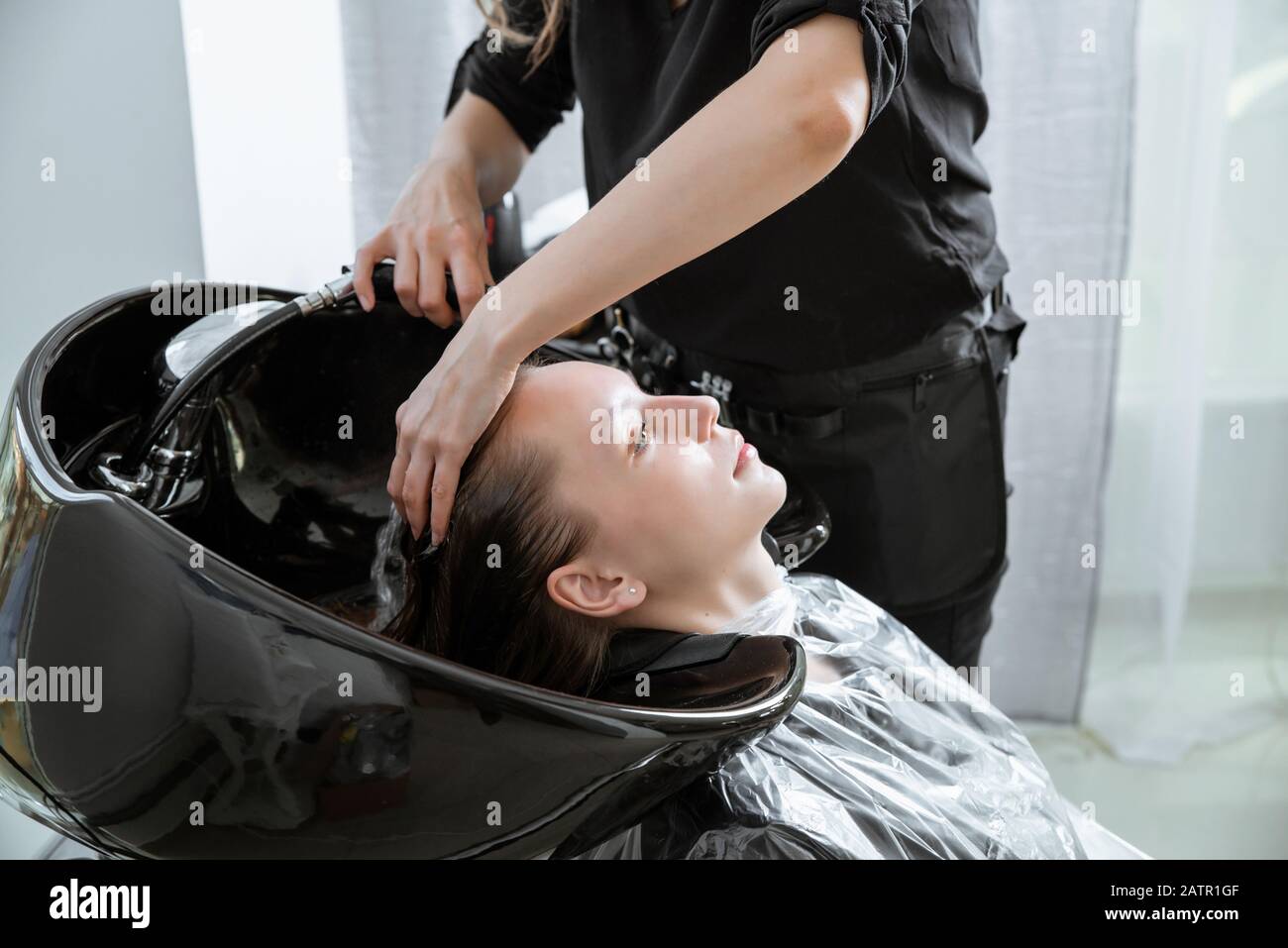 hair stylist washing woman head in hair salon Stock Photo - Alamy
