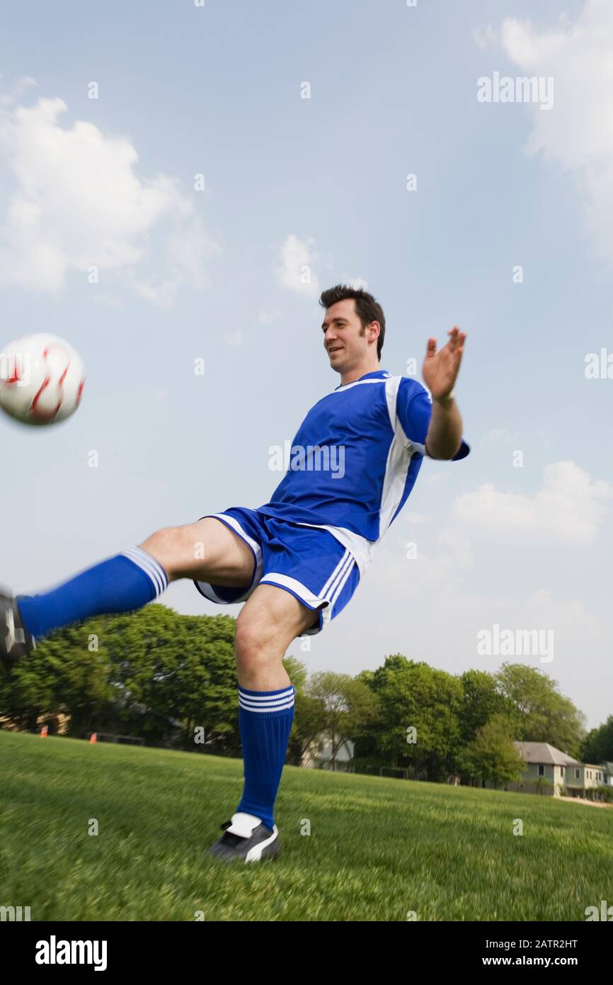 Young man playing with a soccer ball Stock Photo - Alamy