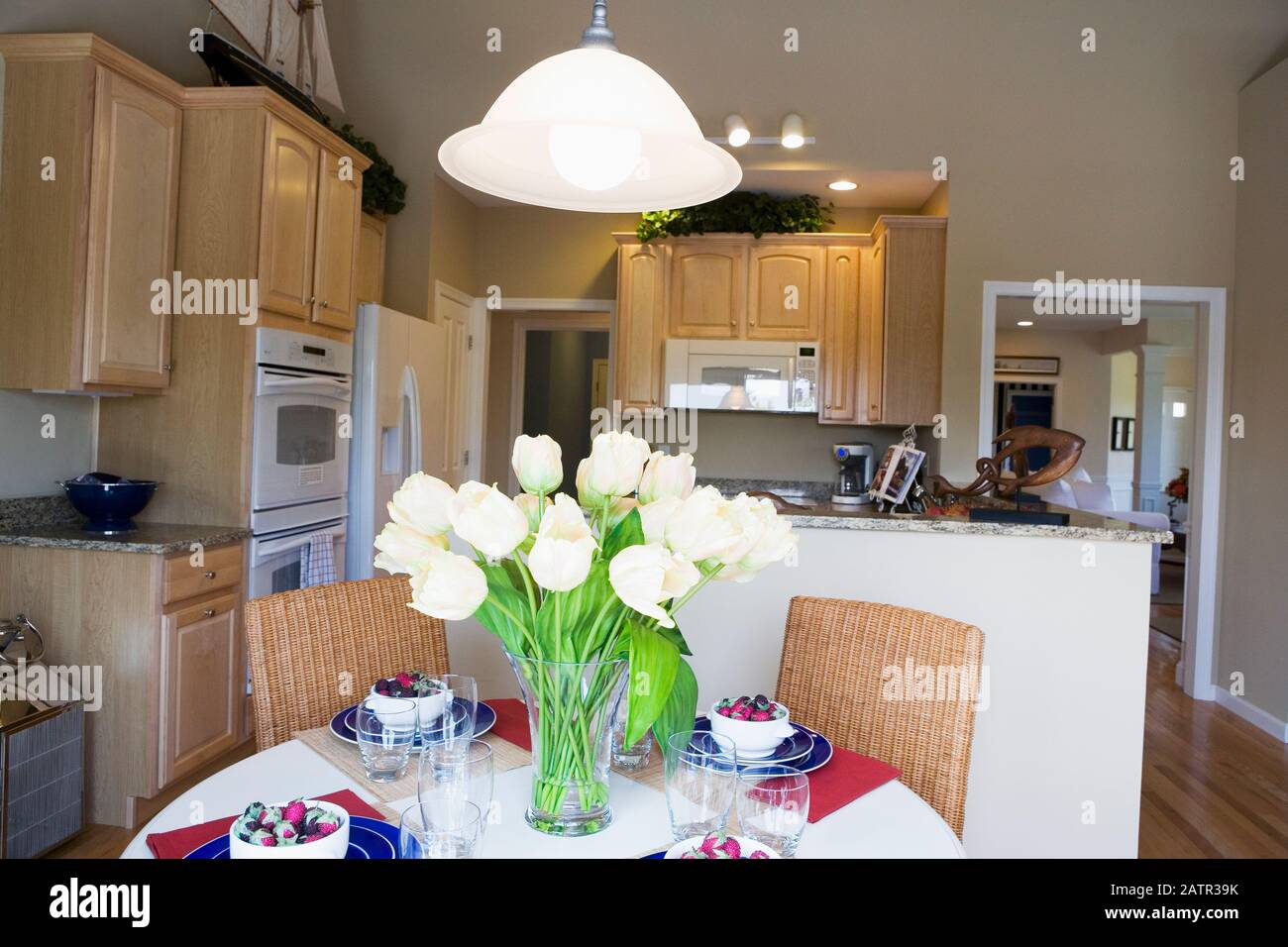 Flowers in a vase on a dining table Stock Photo - Alamy