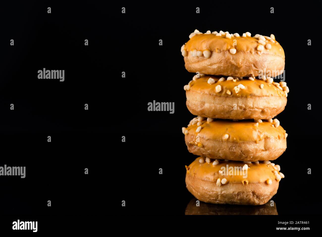 Stack of Salted Caramel Donuts or Doughnuts on Black Background with ...