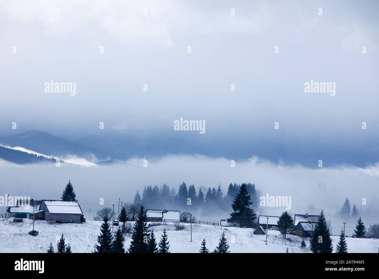 rural scene snowed village in mountains misty fogy morning Stock Photo ...