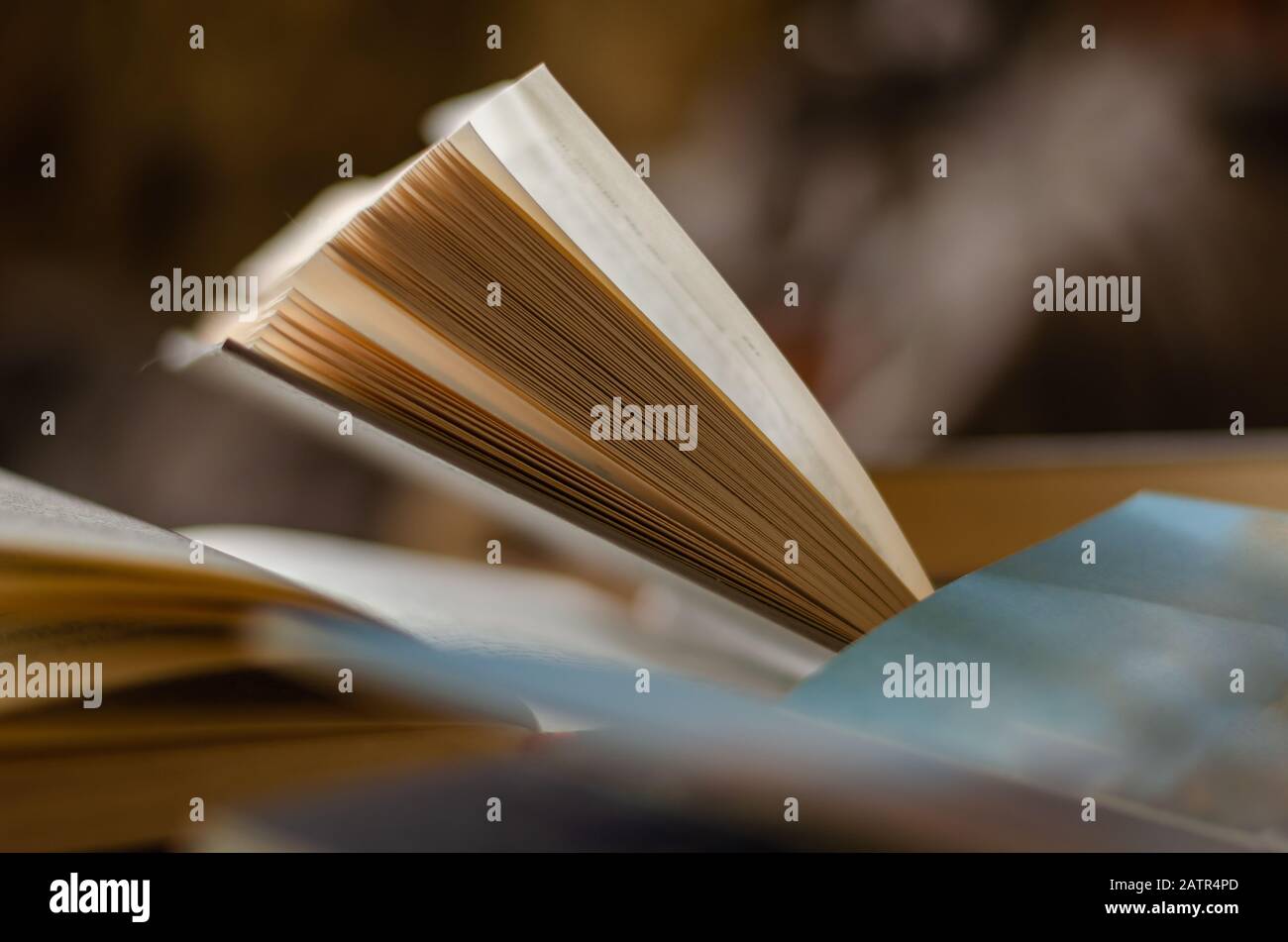 Side view of a textbook on a desk. Selective focus. Eye level shooting ...