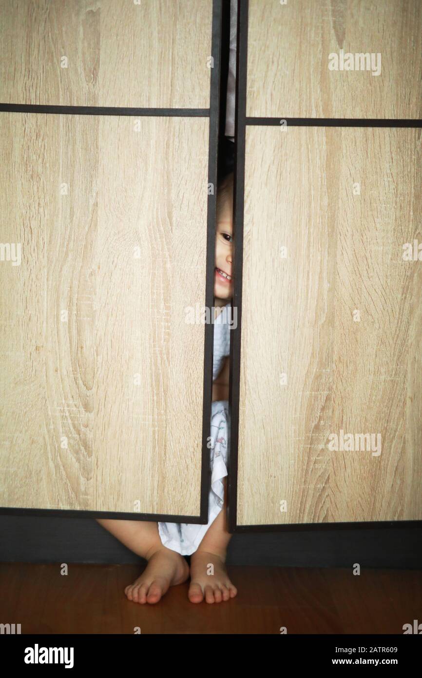 Baby girl hiding face behind hi-res stock photography and images - Alamy