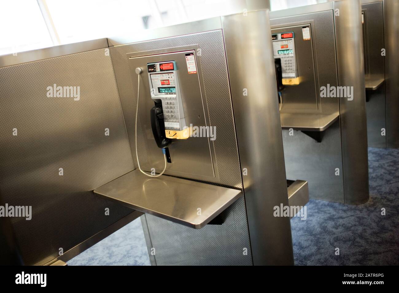 Public pay phones lined up in booths at an airport Stock Photo - Alamy
