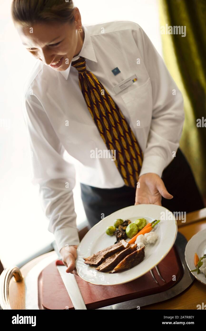 Waiter serving a gourmet meal at a luxury restaurant Stock Photo - Alamy