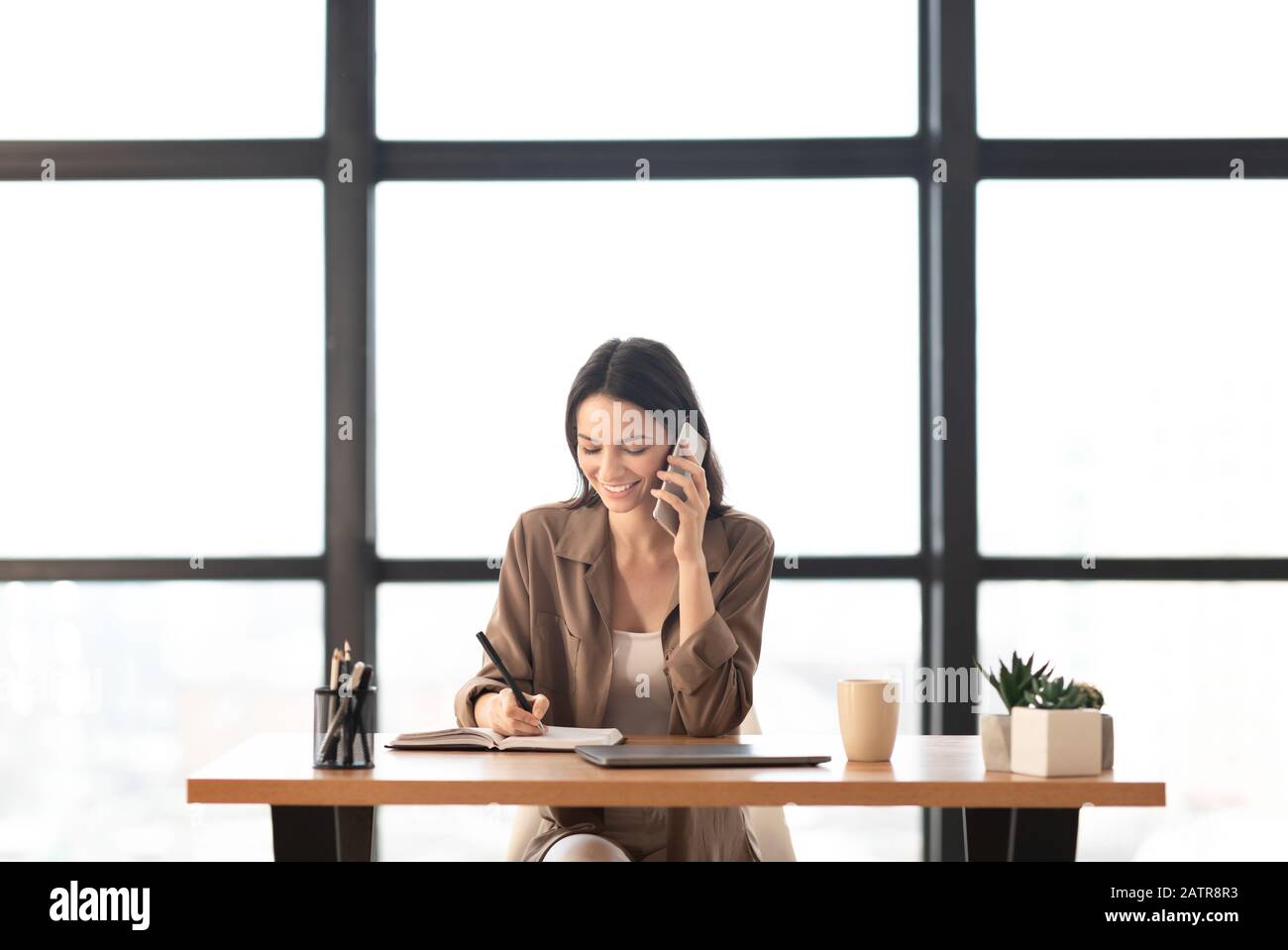 Busy secretary smiling laptop hi-res stock photography and images - Alamy