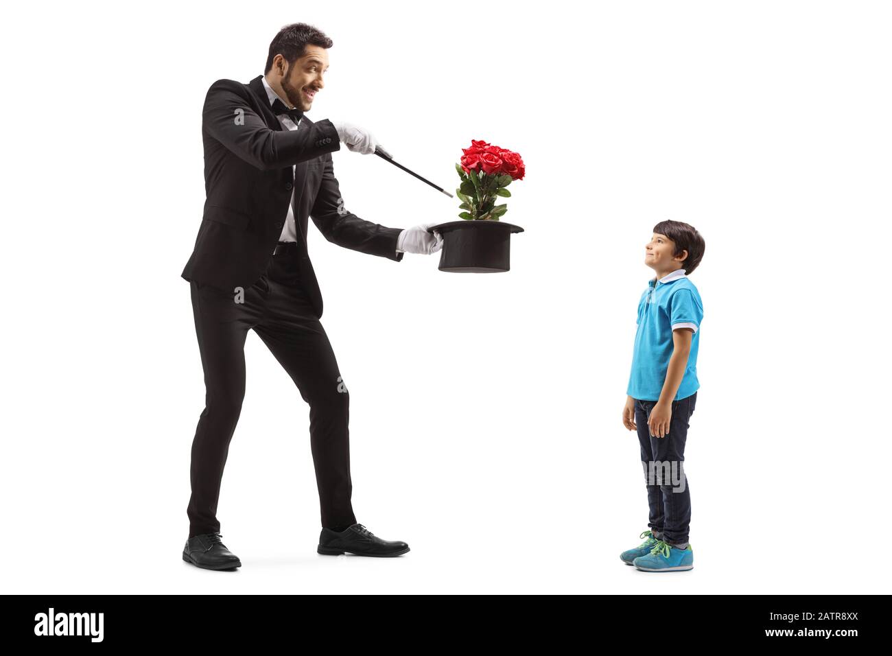 Full length shot of a magician making a hat trick with flowers in front ...