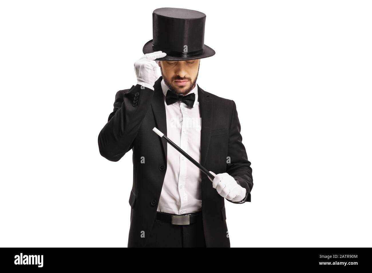 Magician with a magic wand looking down isolated on white background ...
