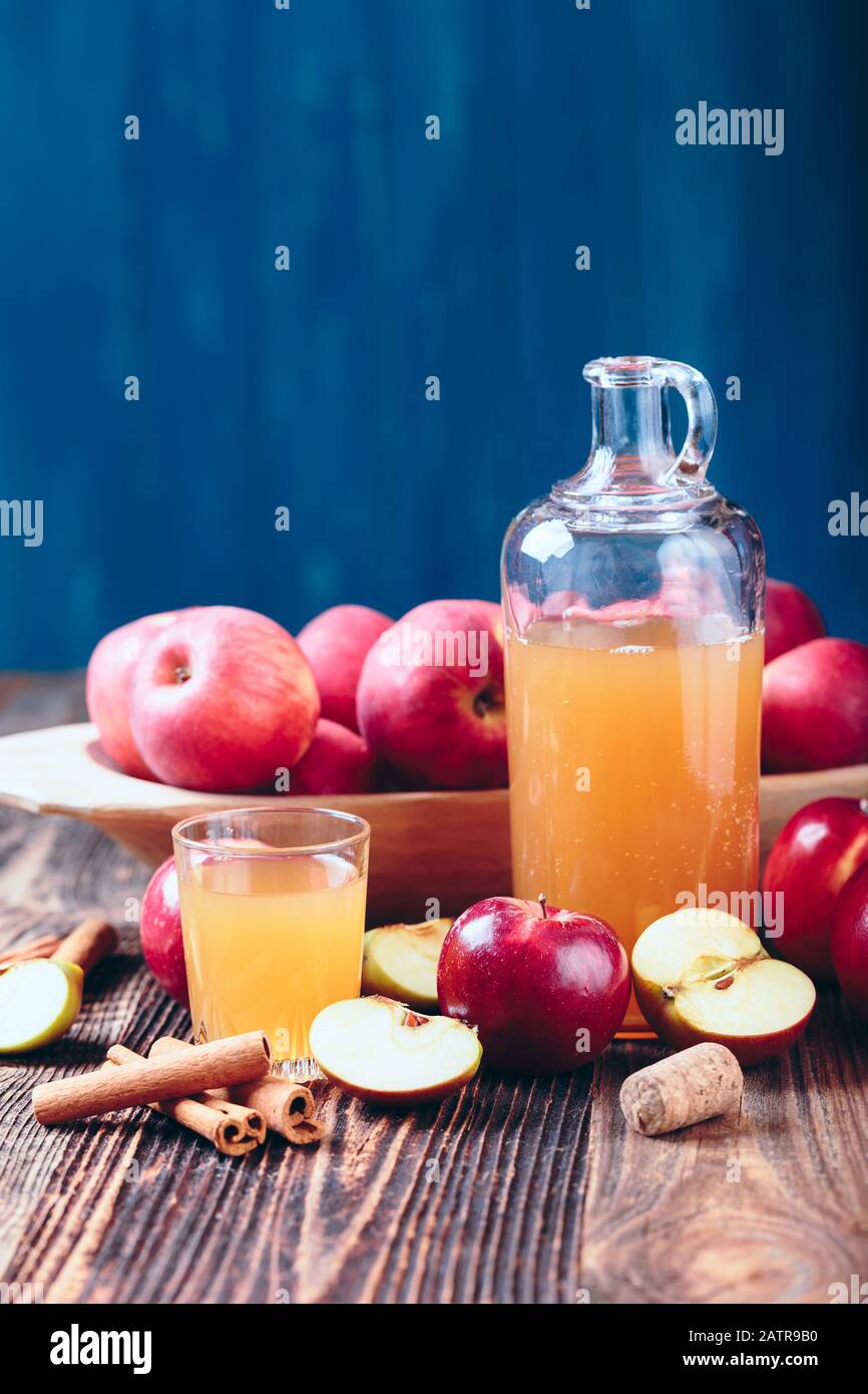 Fresh organic apple cider or apple juice with with cinnamon on the old ...