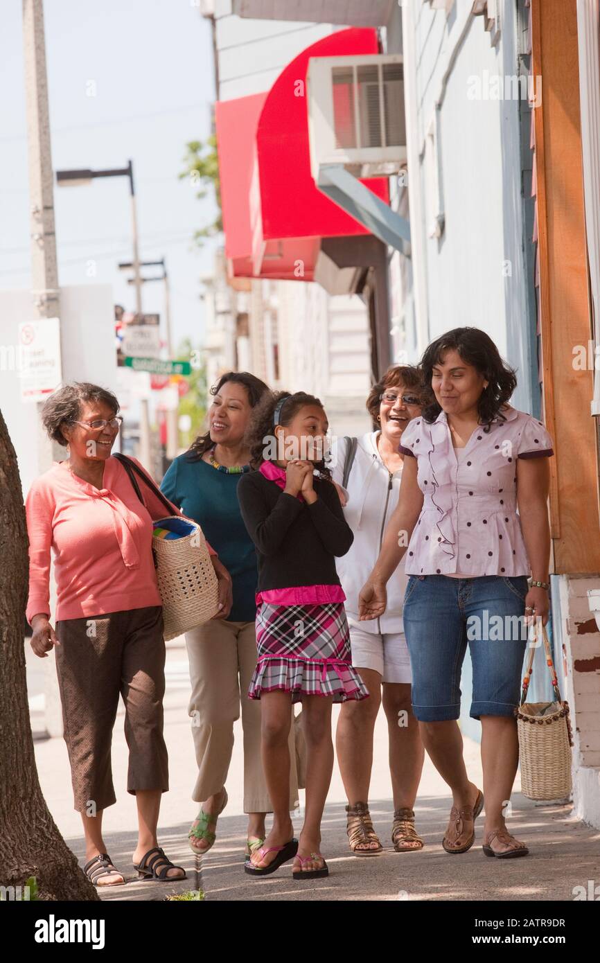 Women from three generations spend time together walking down a ...