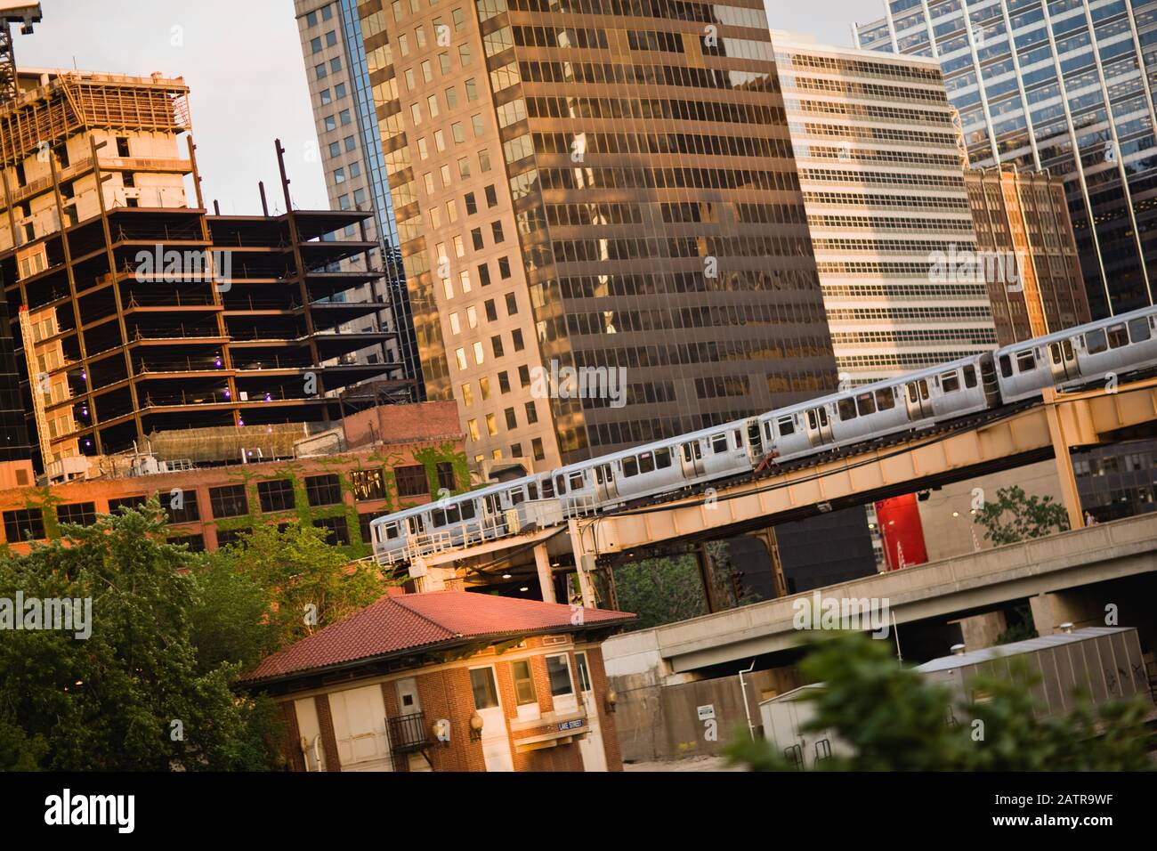 Inner city train traveling on raised railway through buildings in a ...