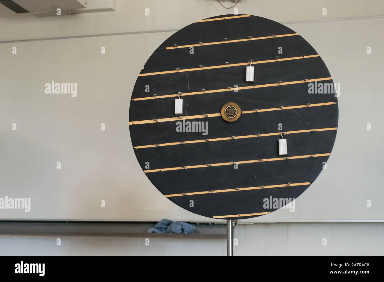 Physics experiment disk and weights demonstrating the principle of the ...