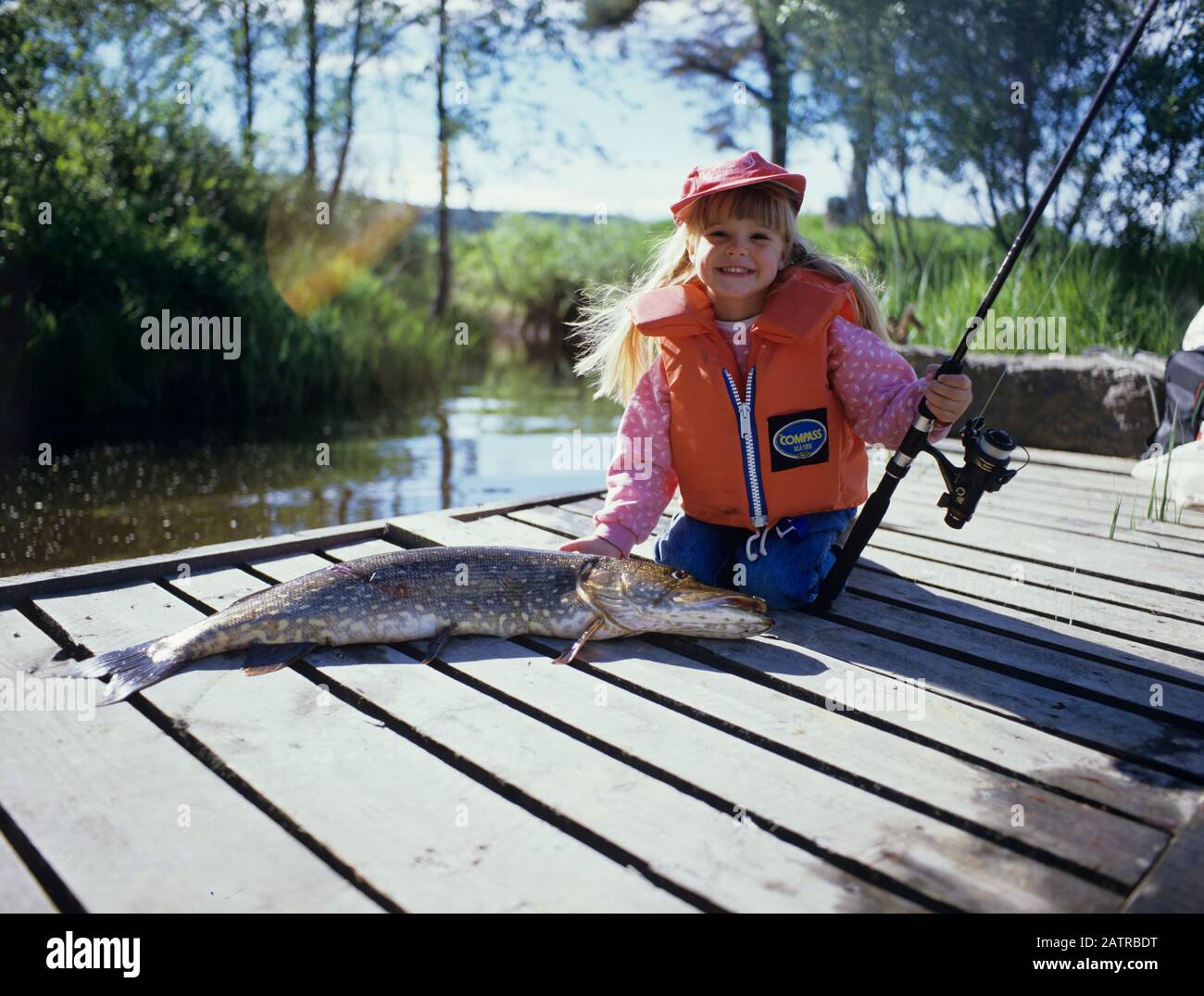 Happy child with big pike catch Stock Photo - Alamy