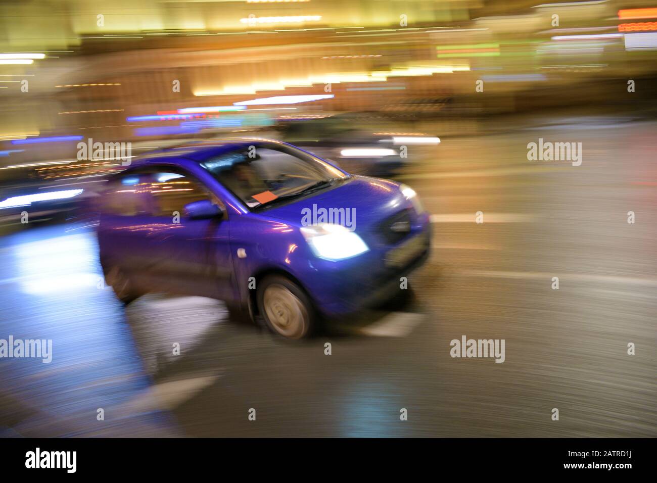High-speed car driving.On the streets of the city glow electric lights ...